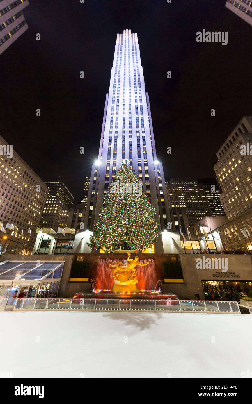 Christmas tree glows in Rockefeller Center among Midtown Manhattan ...