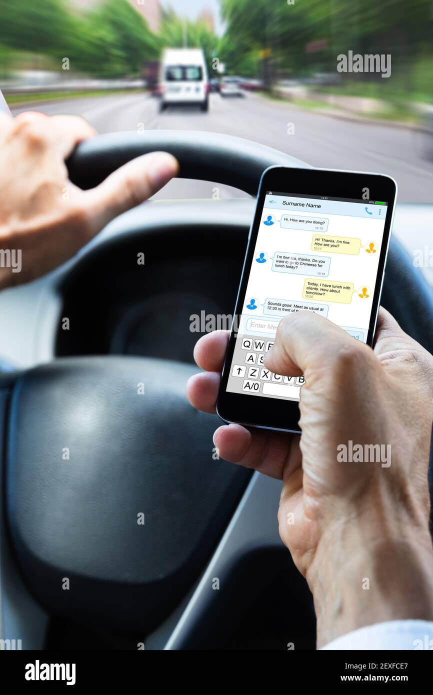 Man Typing Text Message On Mobile Phone While Driving Car Stock Photo ...