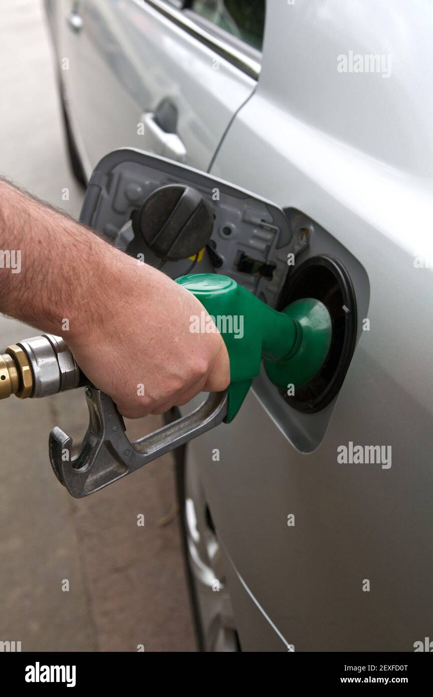 Person fulling a car with petrol or gas Stock Photo - Alamy