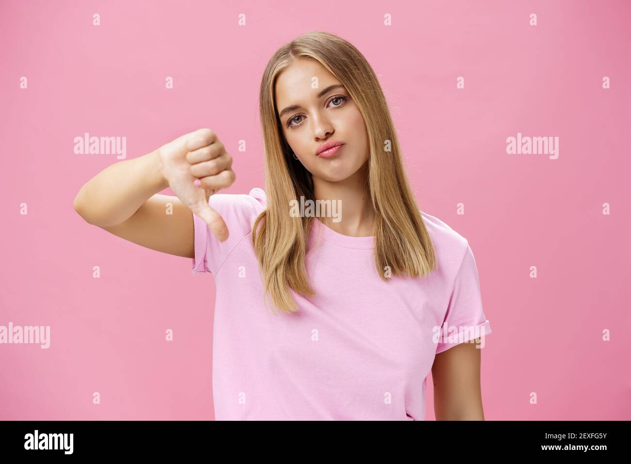 Displeased irritated and moody european woman with fair hair pursing ...