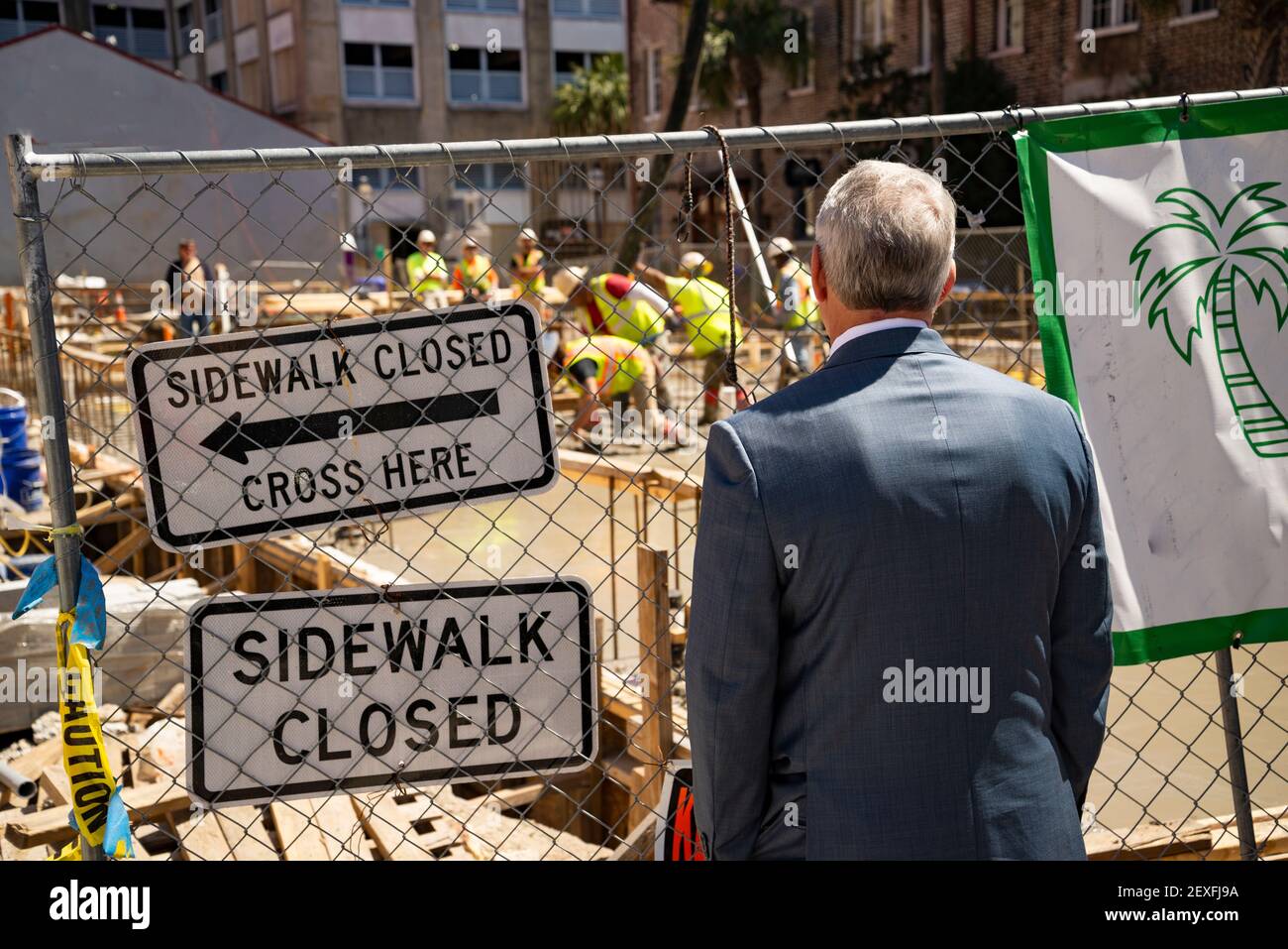 A man look at a street site under construction in Charleston, SC Stock ...