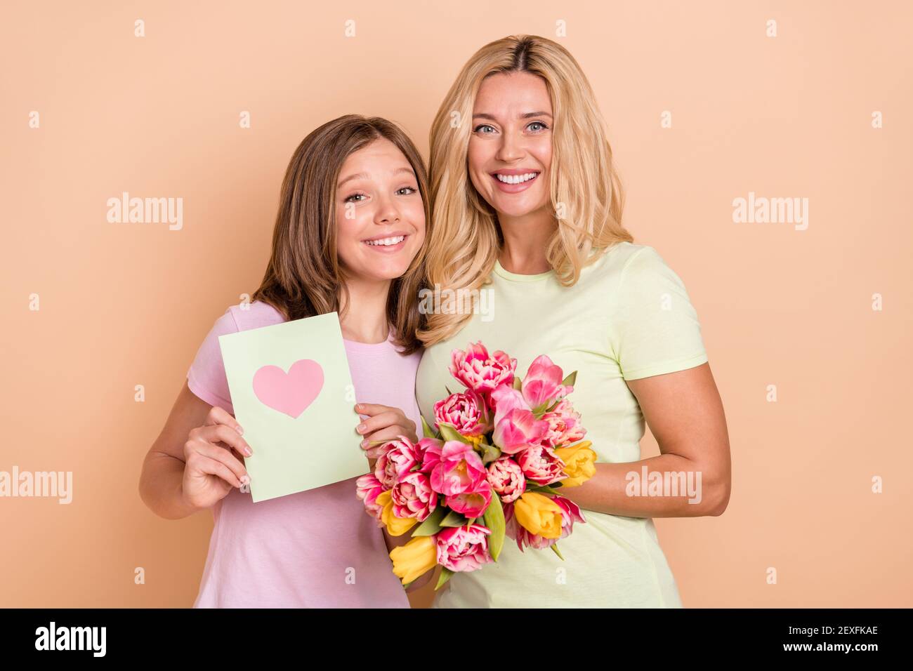 Photo of adorable little girl charming cheerful lady hold flowers paper ...