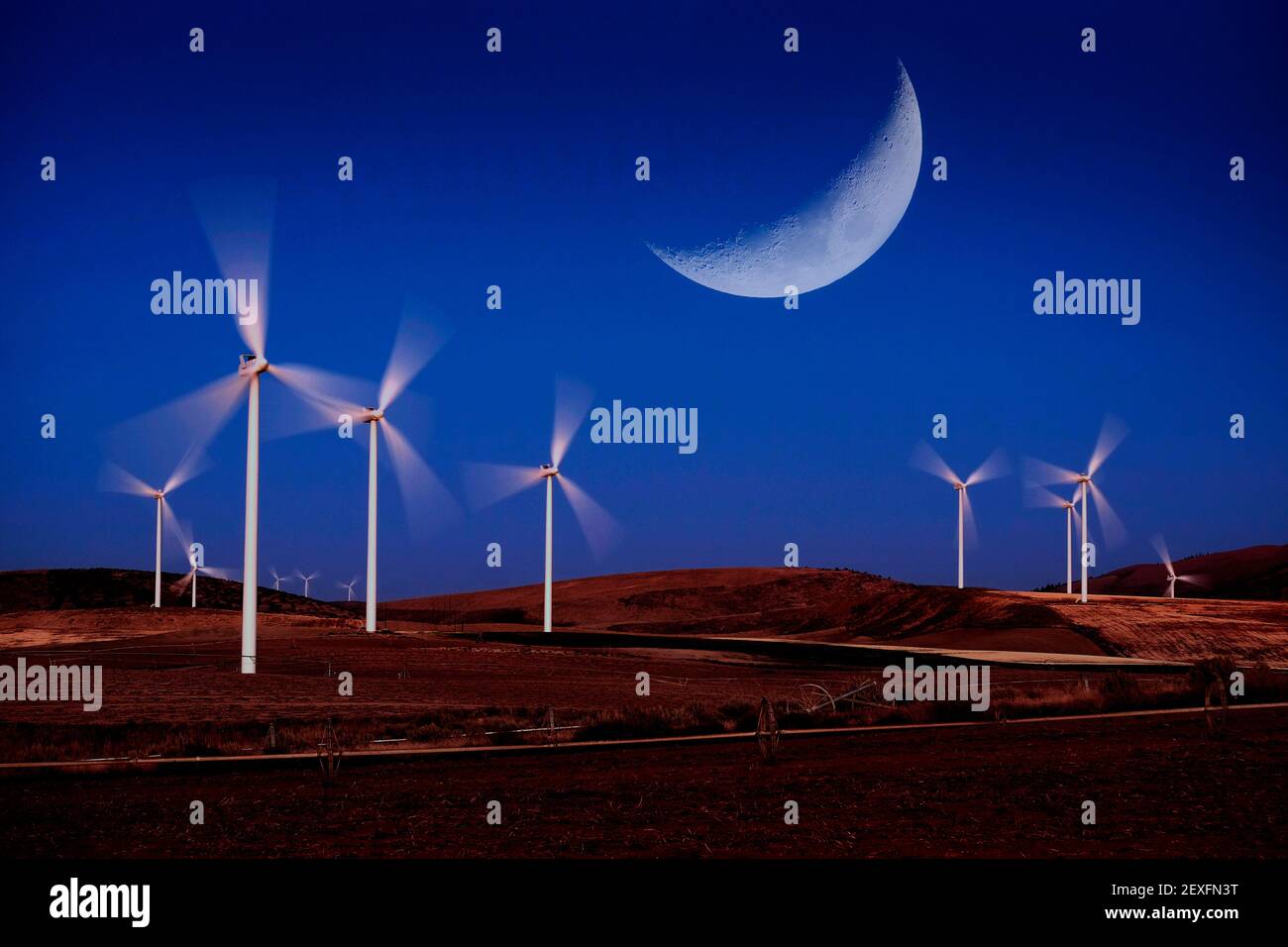 Windmill wind turbines spinning fast in wind with moon light Stock ...