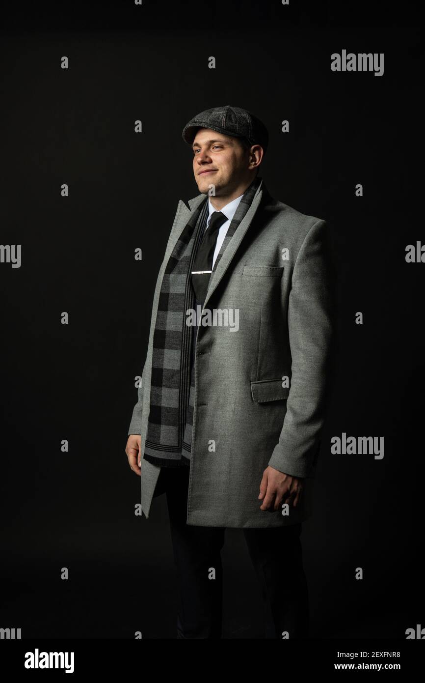 in a coat and a cap a scarf Young male three piece suit male attractive ...