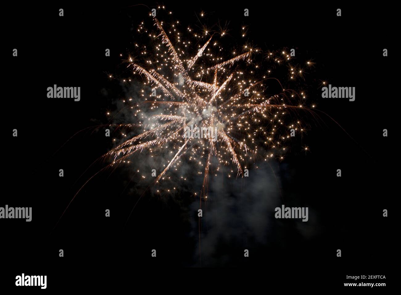 Fireworks explode into a ball of sparks Stock Photo - Alamy