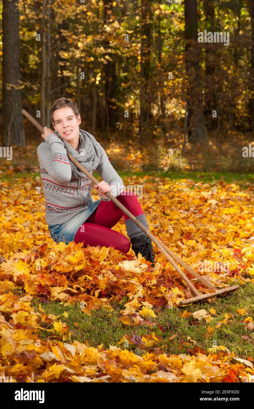 Woman leaves rake hi-res stock photography and images - Alamy