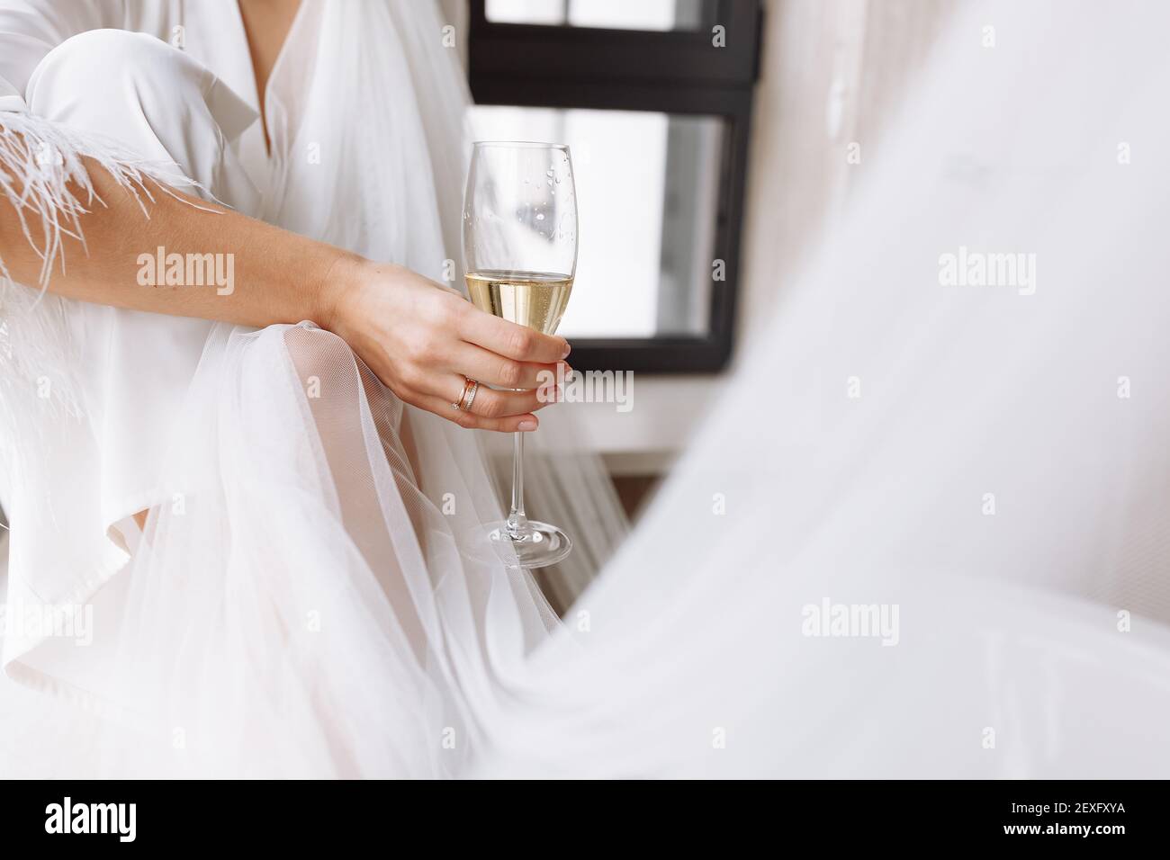 Bride s morning. Bride drinking champagne in the peignoir. young woman ...