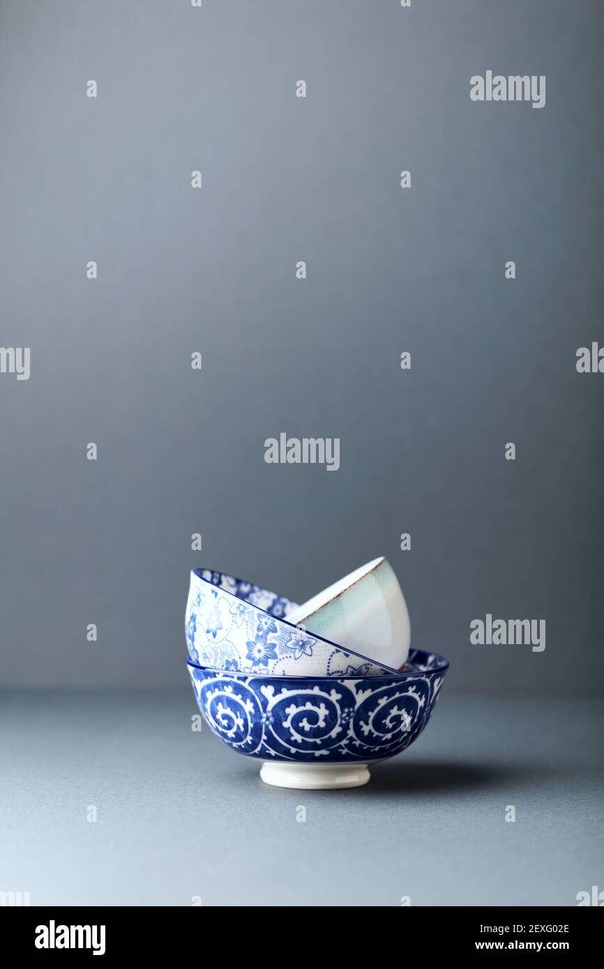 Traditional ceramic bowls on paper background. Copy space Stock Photo ...