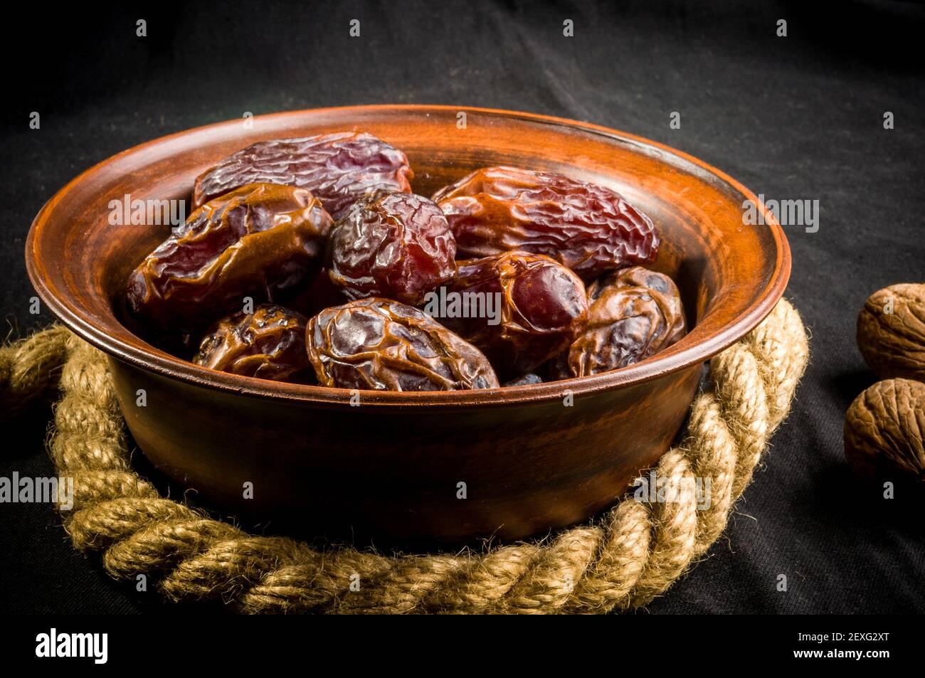 Big luxury dried date fruit in bowls on the dark surface, kurma ramadan ...