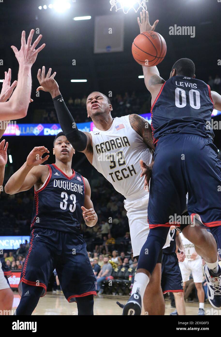 Duquesne center Darius Lewis defends against Georgia Tech forward Nick ...