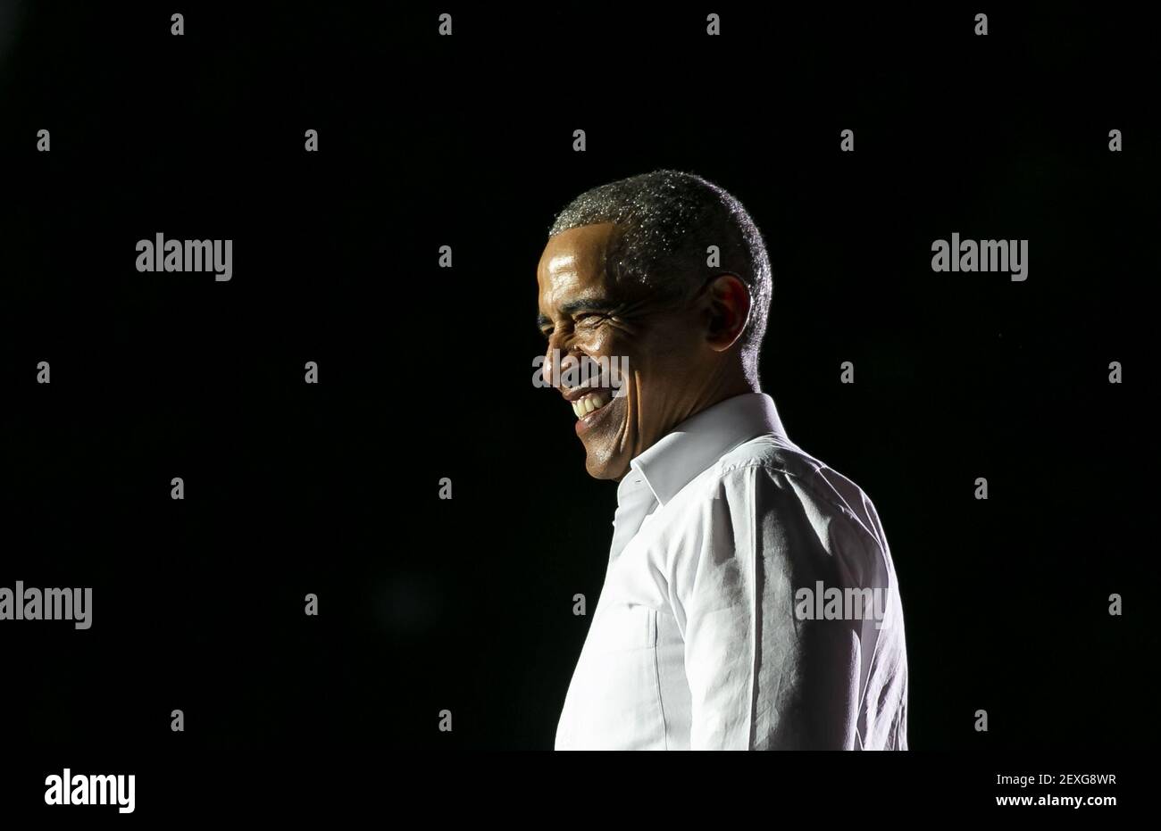 Former President Barack Obama speaks during a drive-in rally near ...