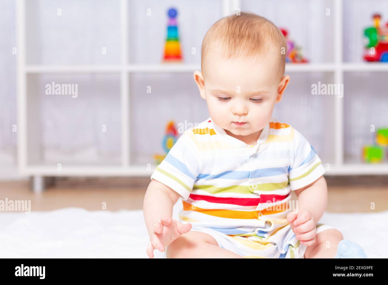 Boy sitting down on the floor hi-res stock photography and images - Alamy
