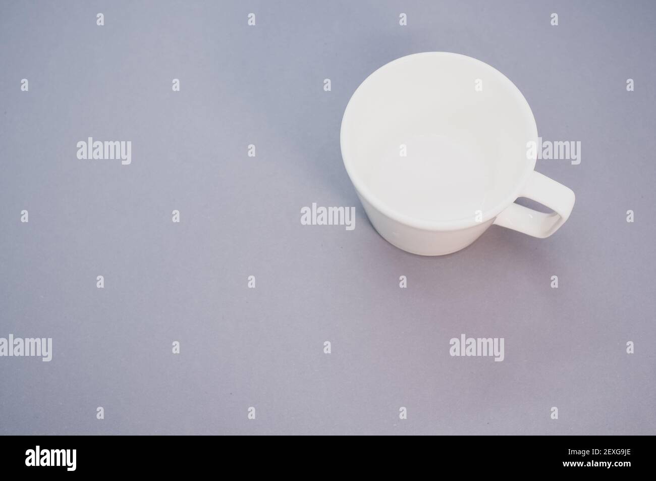 An empty white plastic cup isolated on a grey background Stock Photo ...