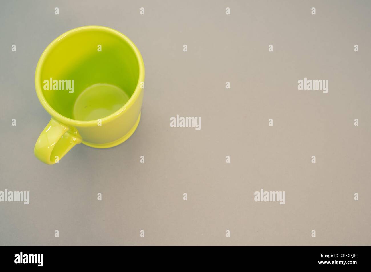 An empty green plastic cup isolated on a grey background Stock Photo ...