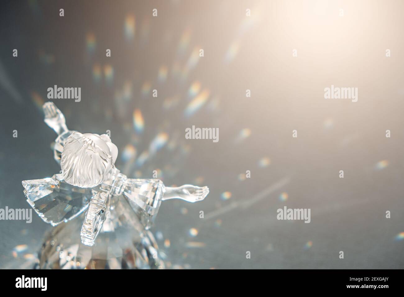 Crystal glass angel in the rays of the sun with reflecting, embossed ...