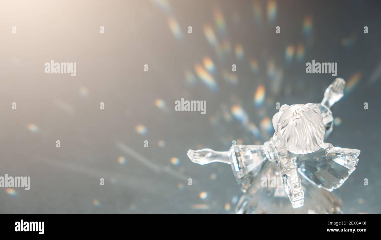 Crystal glass angel in the rays of the sun with reflecting, embossed ...