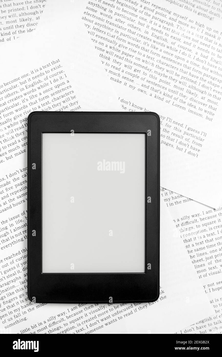 Electronic reader off on sheets of paper with text printed on them ...
