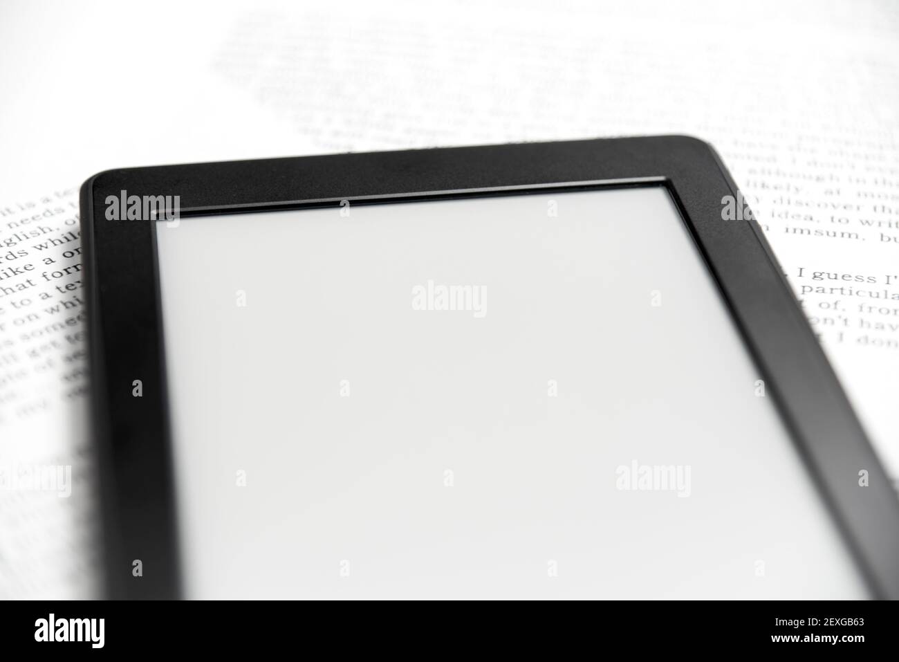 Detail of an electronic reader with blank screen on sheets of paper ...
