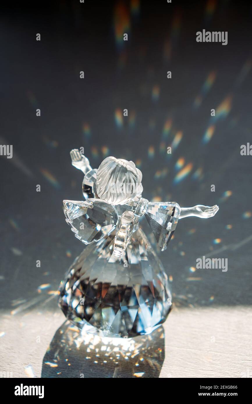 Crystal glass angel in the rays of the sun with reflecting, embossed ...