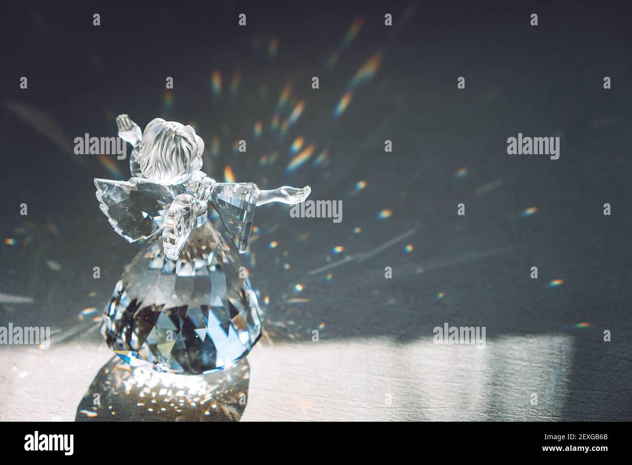 Crystal glass angel in the rays of the sun with reflecting, embossed ...
