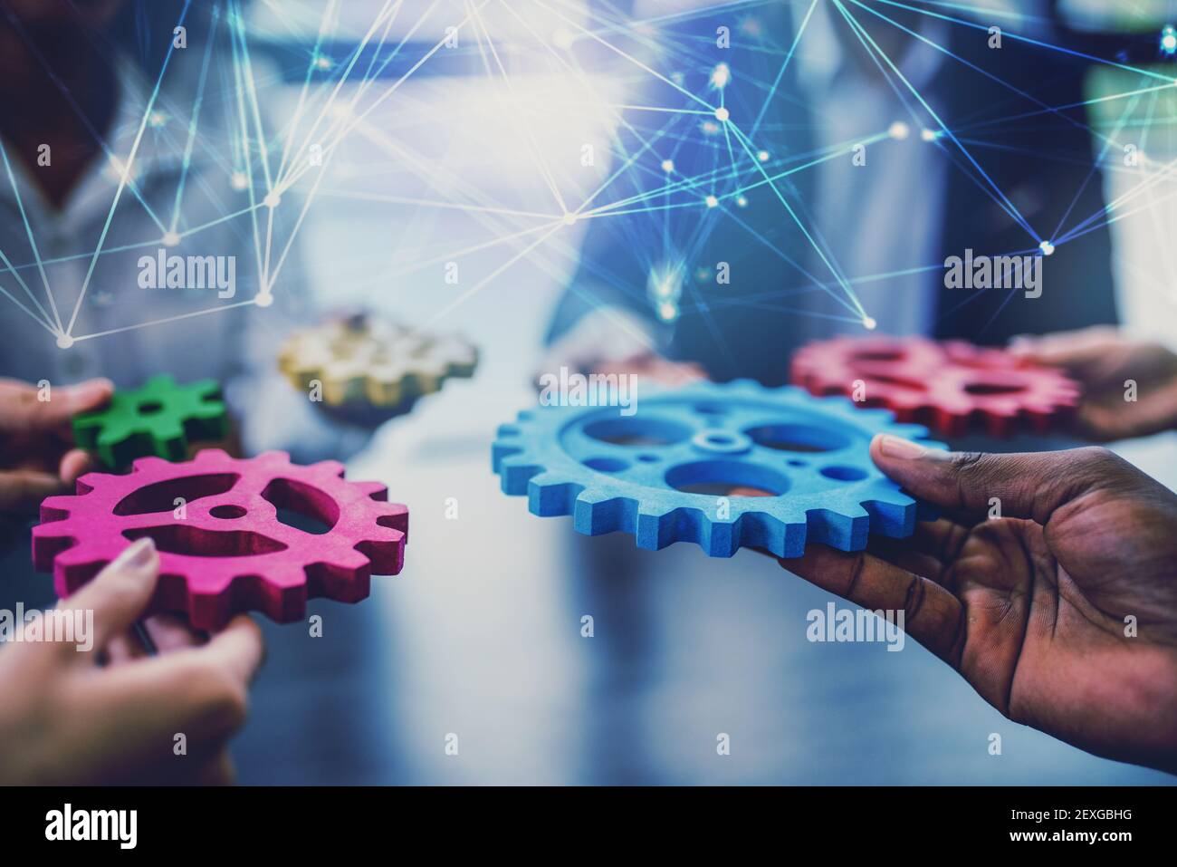 Group of people connect single colored cogwheels to make a gear ...
