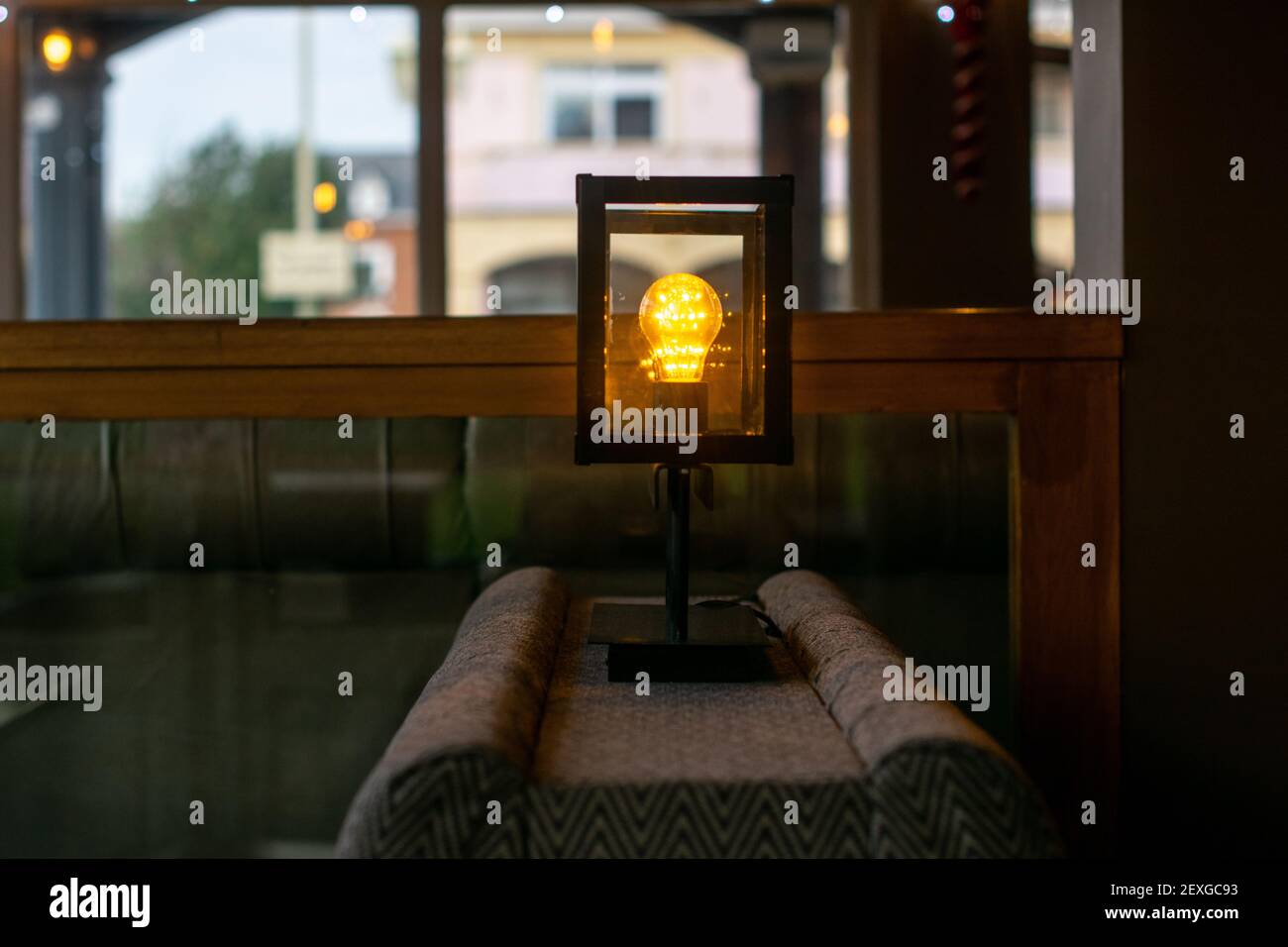 A single illuminated lightbulb in a decorative lamp Stock Photo - Alamy