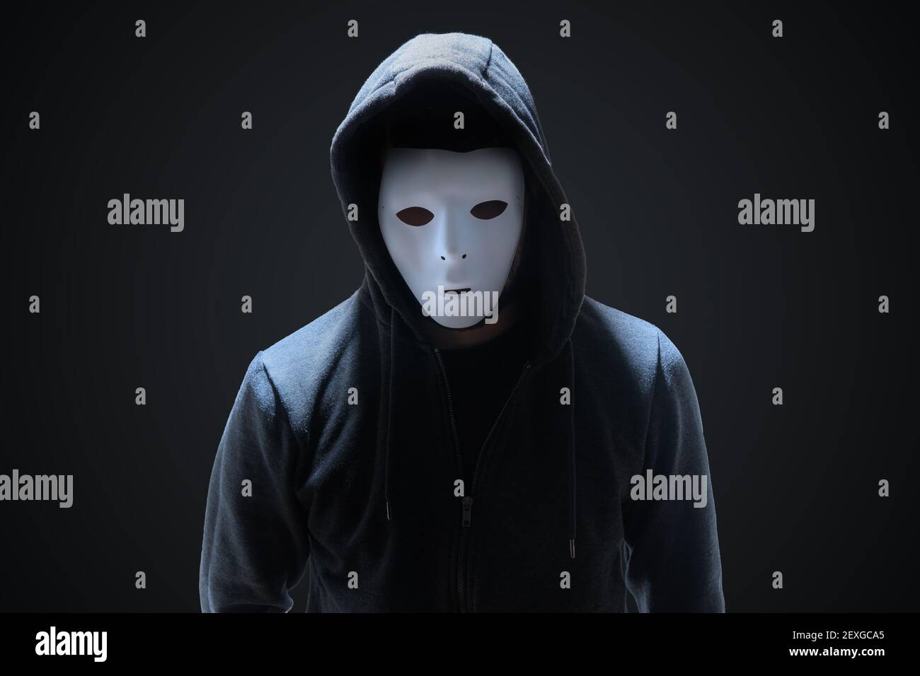 Masked anonymous hacker on black background Stock Photo - Alamy