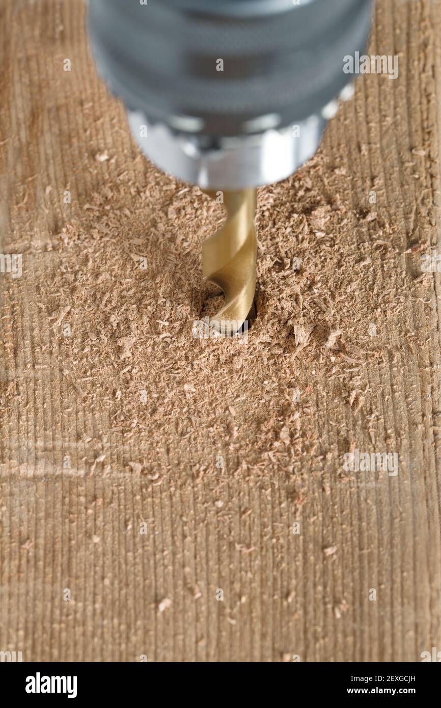 Drilling a wood plank Stock Photo - Alamy
