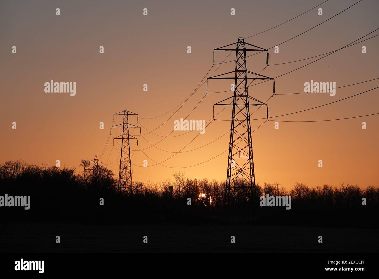 The high voltage electrical tower with wiring on a beautiful sunset ...