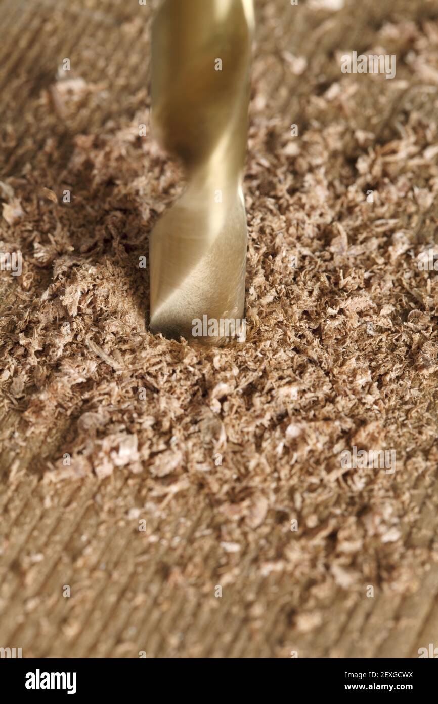 Drilling a hole piece of wood plank Stock Photo - Alamy