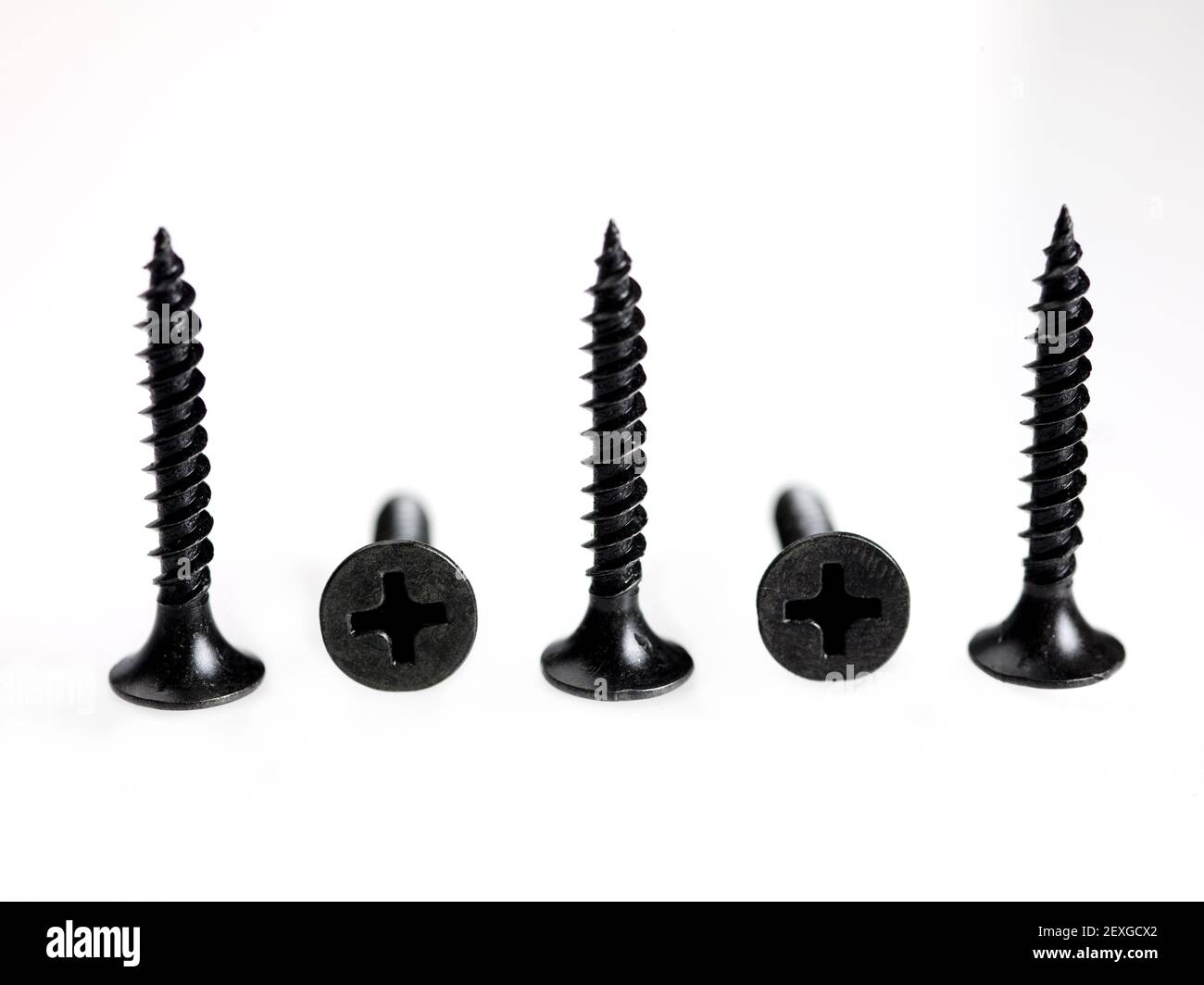 Five black screws Stock Photo - Alamy