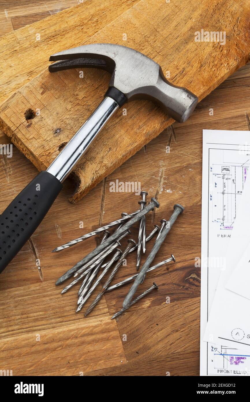 Hammer on table with nails Stock Photo - Alamy