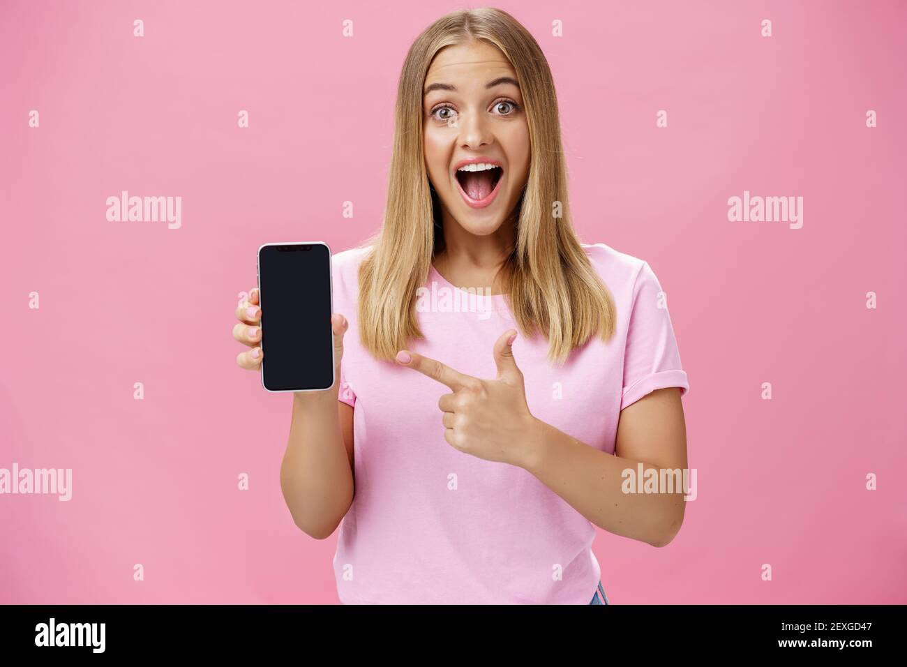 Portrait of excited and amused charming pleased female client using new ...