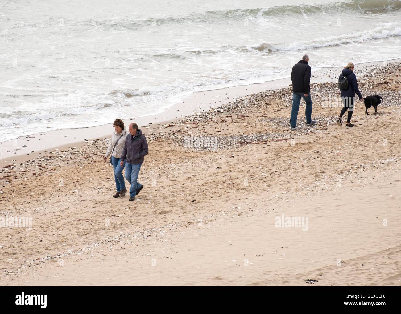People walking on a beach example Stock Photo - Alamy