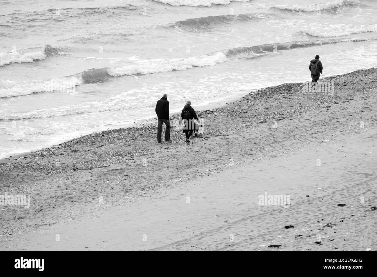 People walking on a beach example Stock Photo - Alamy