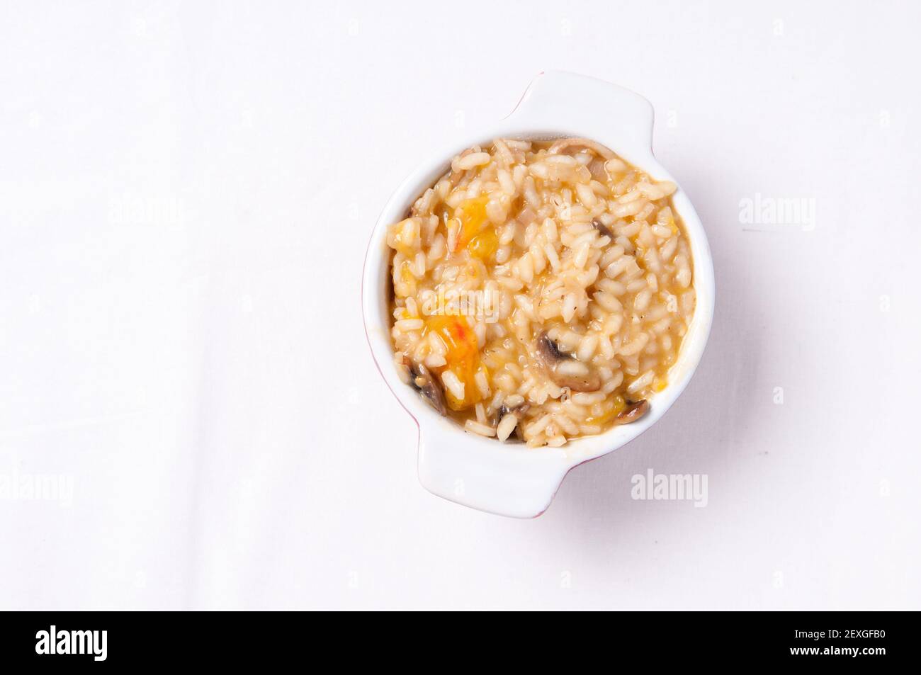 creamy tomato and mushroom risotto ready to eat Stock Photo - Alamy