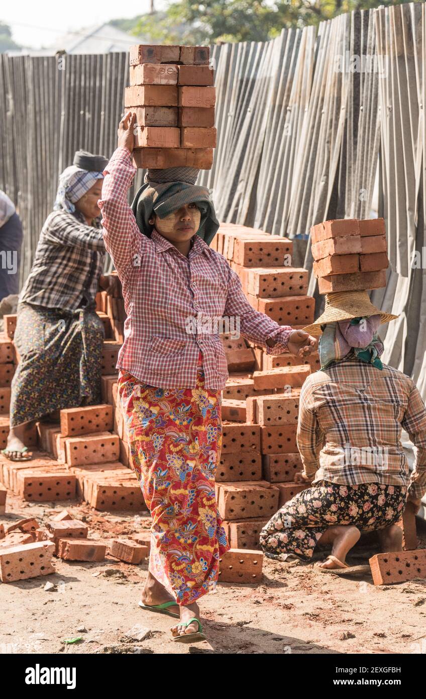 Carrying bricks on their head hi-res stock photography and images - Alamy