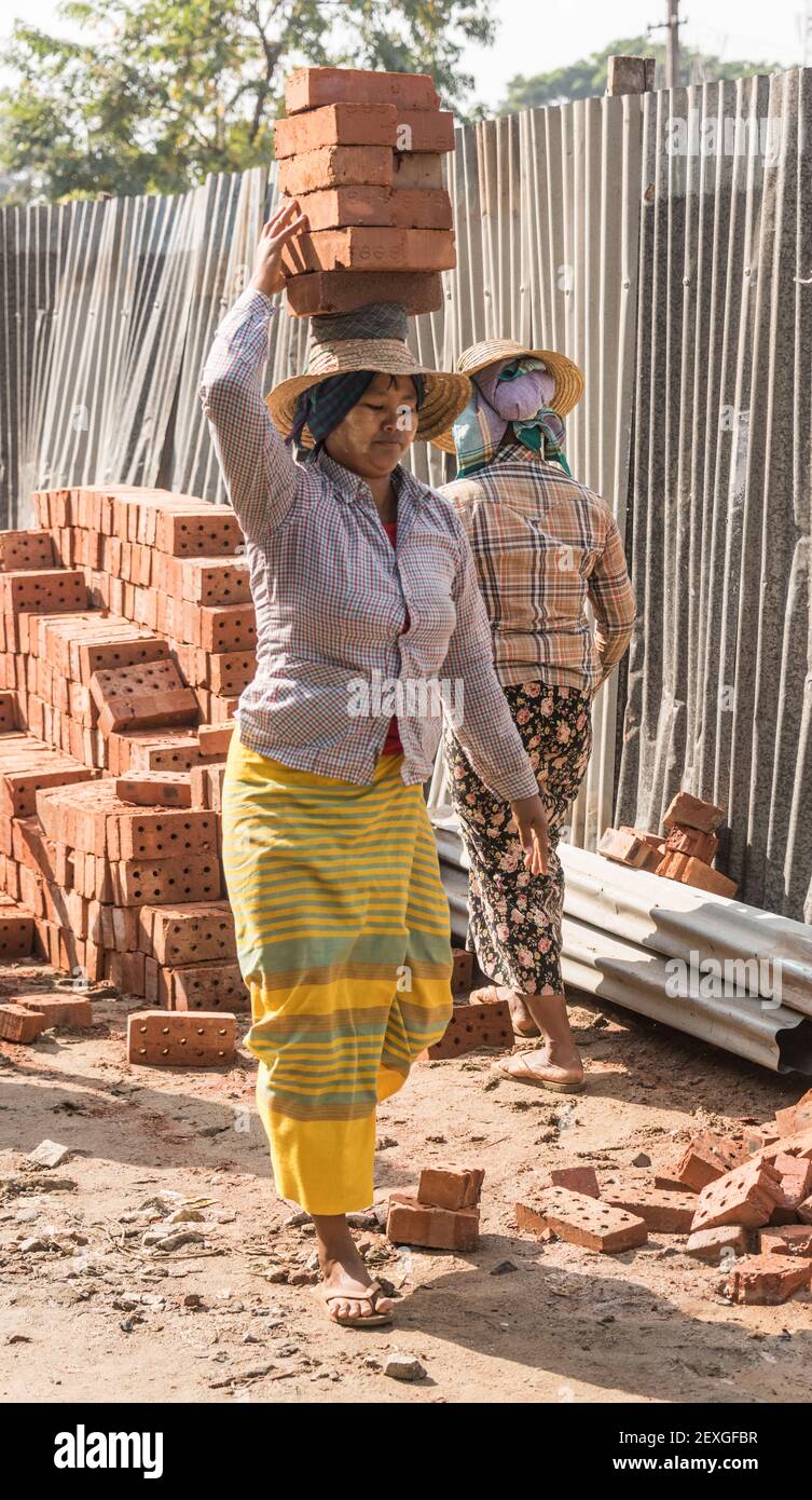 Women carrying bricks on a building site in Mandalay, Myanmar Stock ...