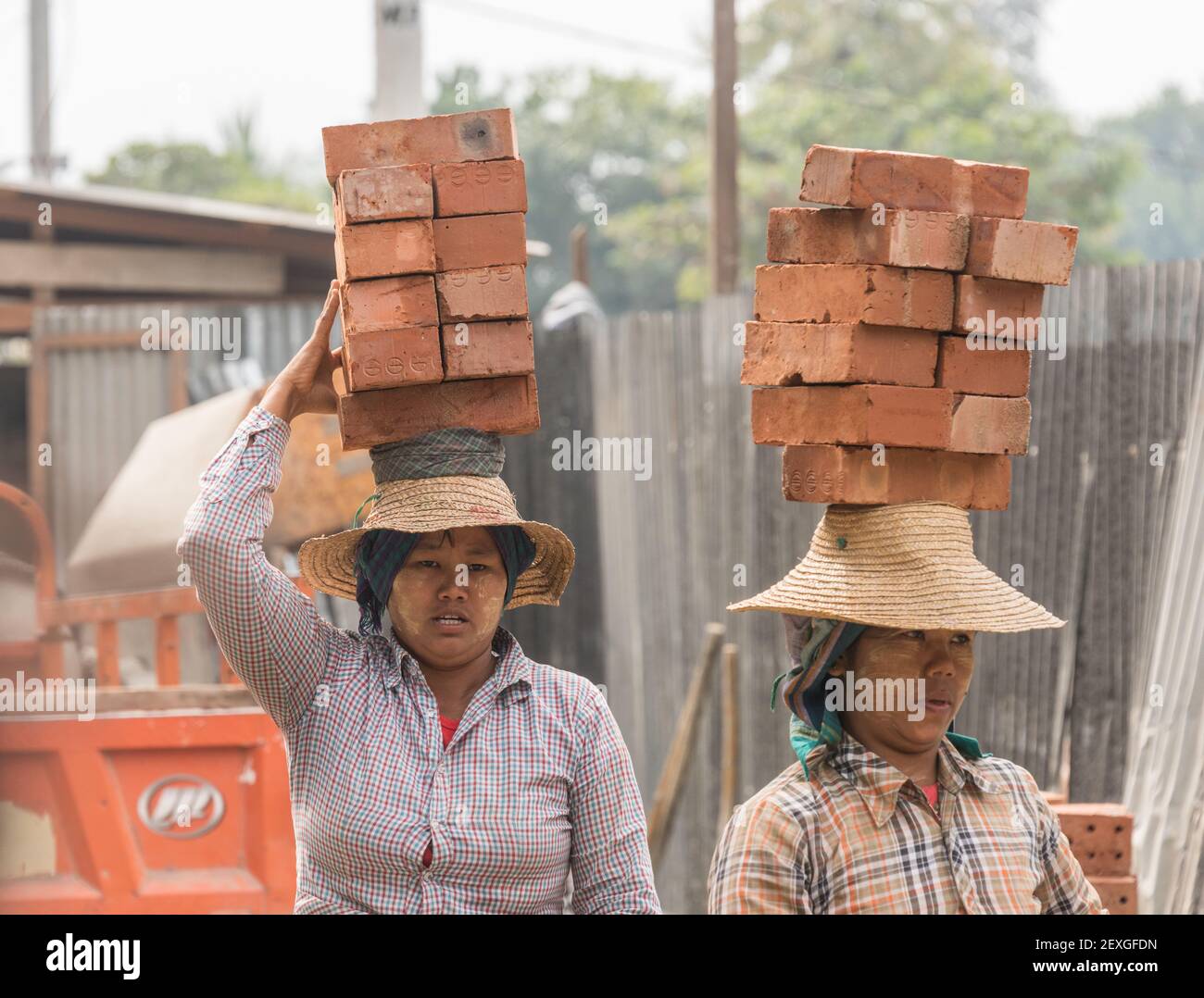 Women carrying bricks hi-res stock photography and images - Alamy
