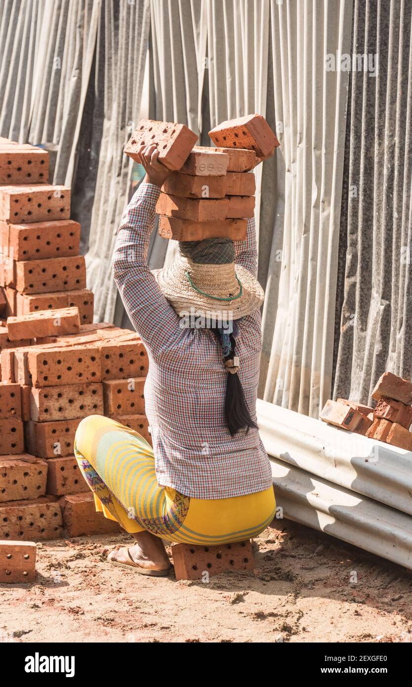 Women carrying bricks on a building site in Mandalay, Myanmar Stock ...