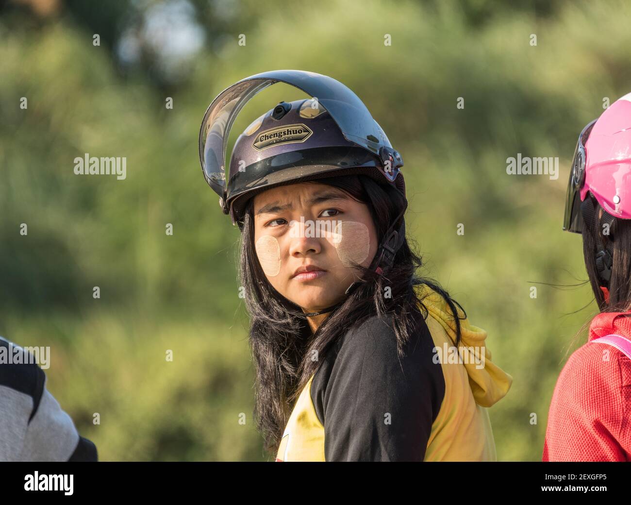 Girl with motorcycle crash helmet in Myanmar village Stock Photo - Alamy