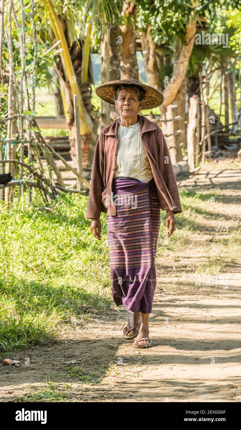 Woman walking in village country lane, Myanmar Stock Photo - Alamy