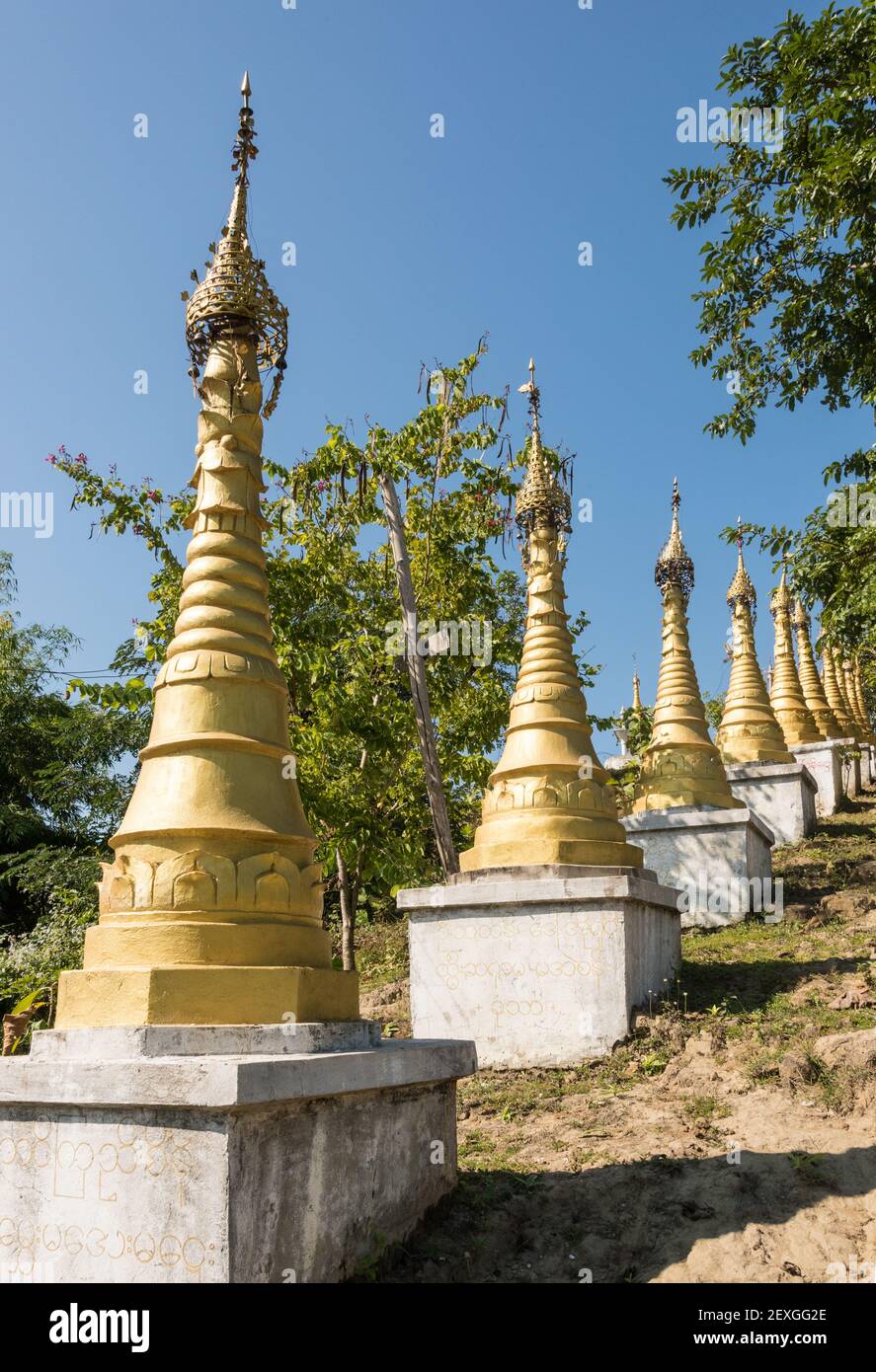 Line of stupas outside traditional village, Myanmar Stock Photo - Alamy