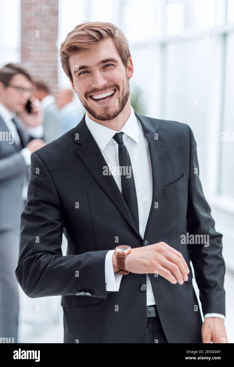 smiling business men standing in the office Stock Photo - Alamy