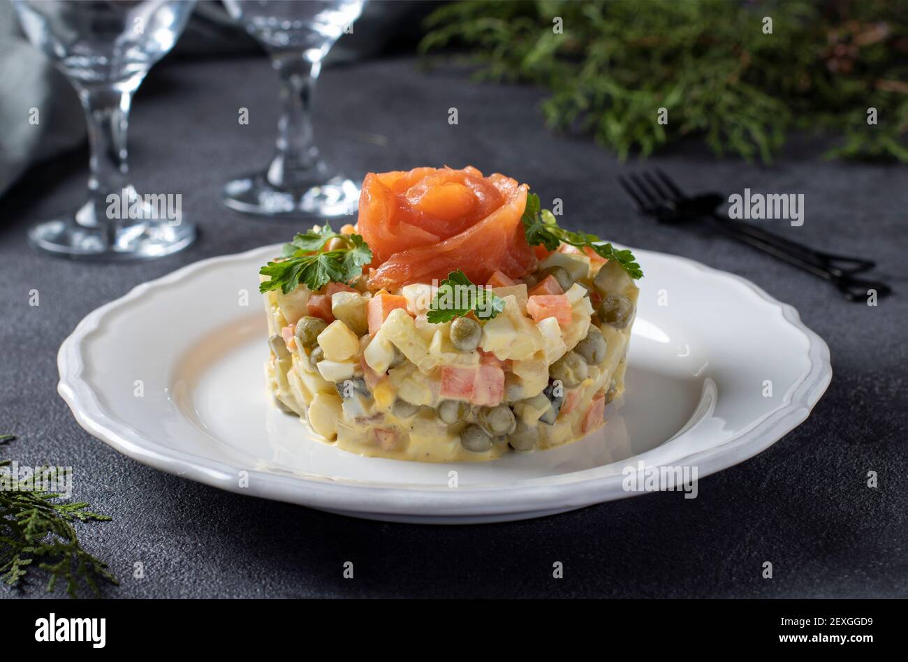 Traditional Russian salad Olivier with salted salmon on a dark ...