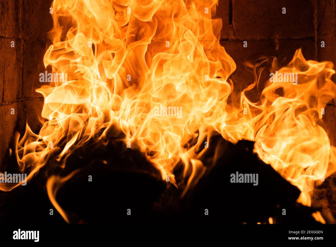 Burning cozy fire with logs. Glowing fireplace. Fire texture. Flame ...