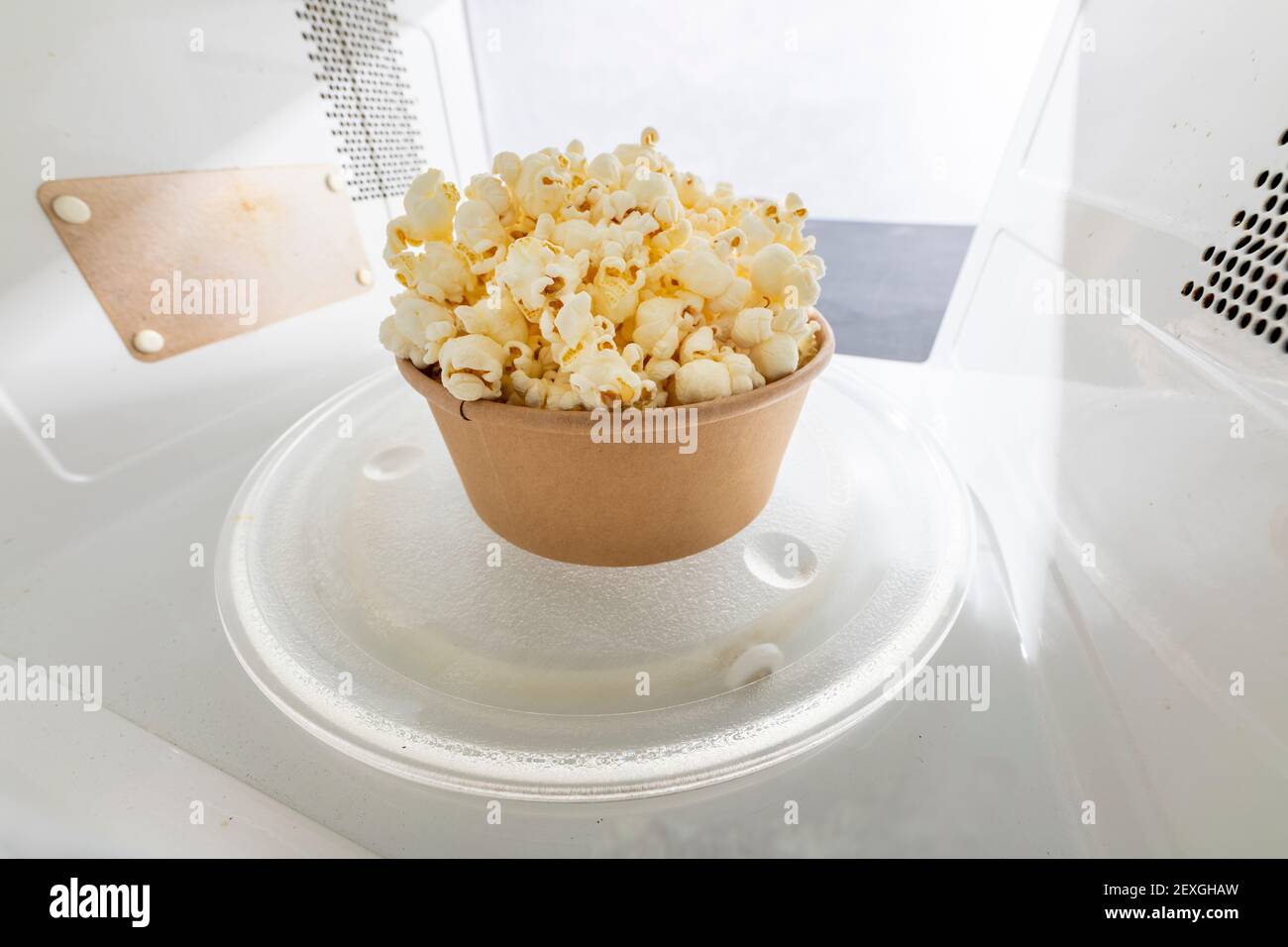 Ready popcorn set in the microwave oven. Salty snack prepared in the ...