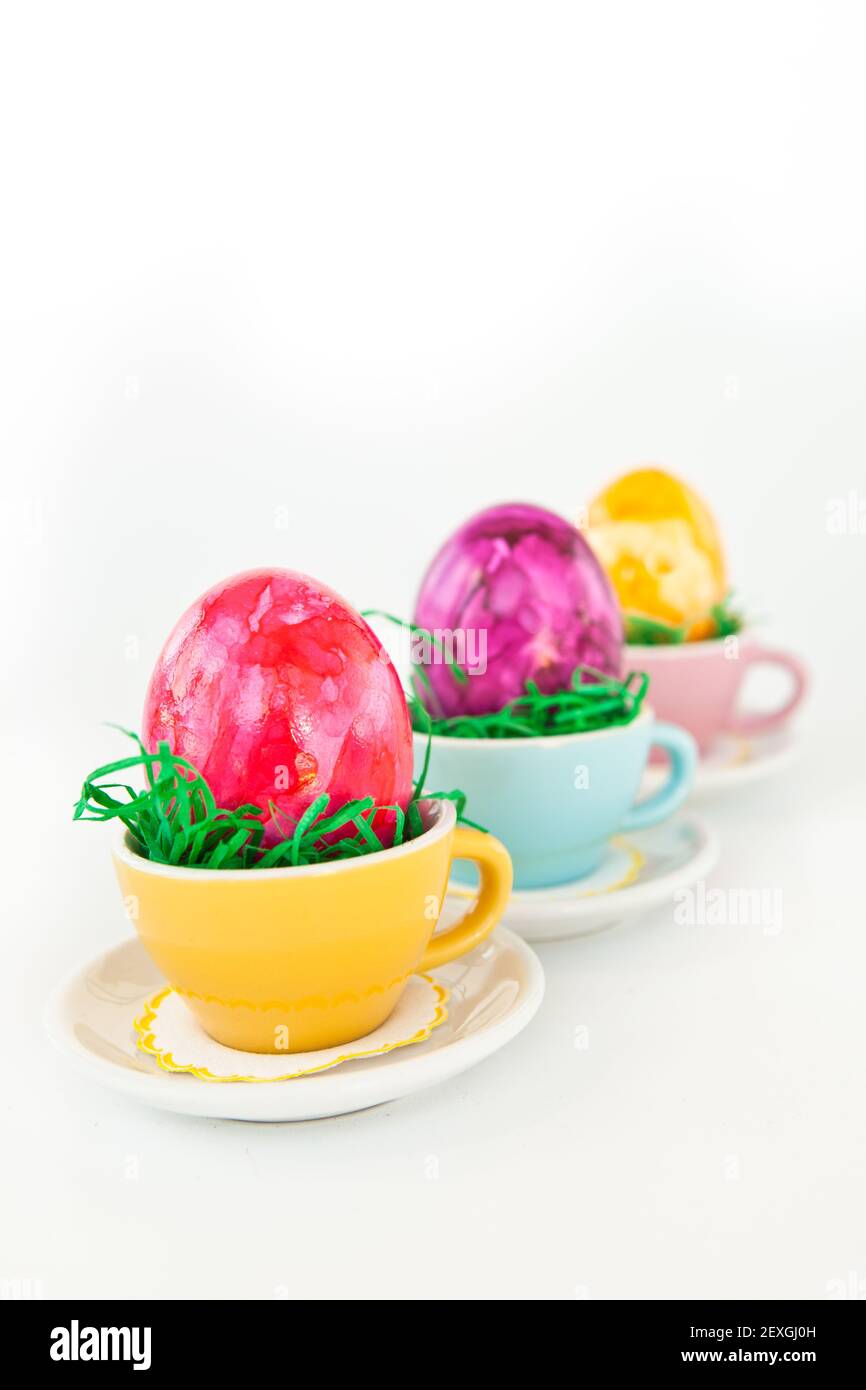 Colourful easter eggs in small cups Stock Photo - Alamy