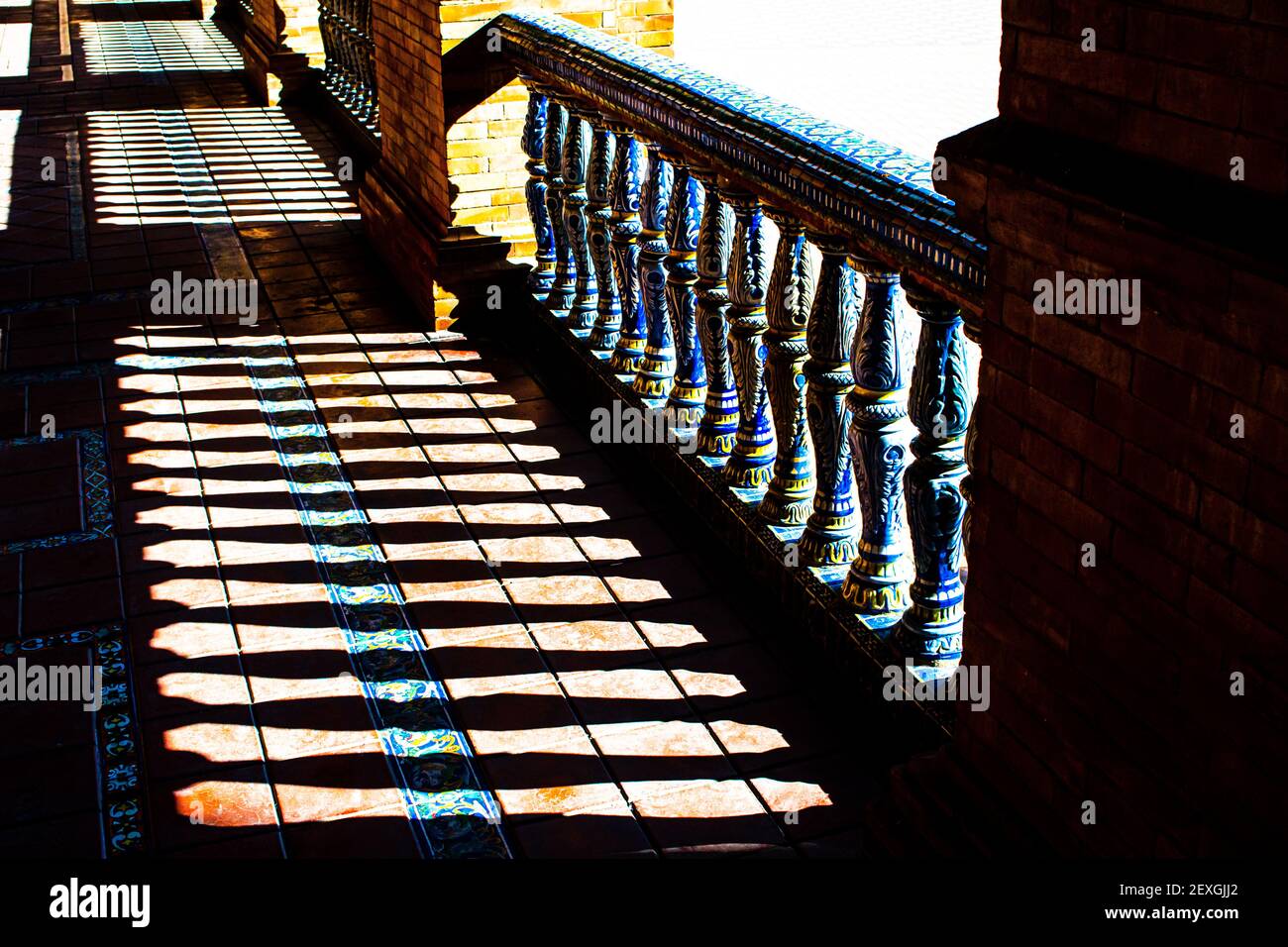 The shadow of railings with sculptures falling on the grou Stock Photo ...