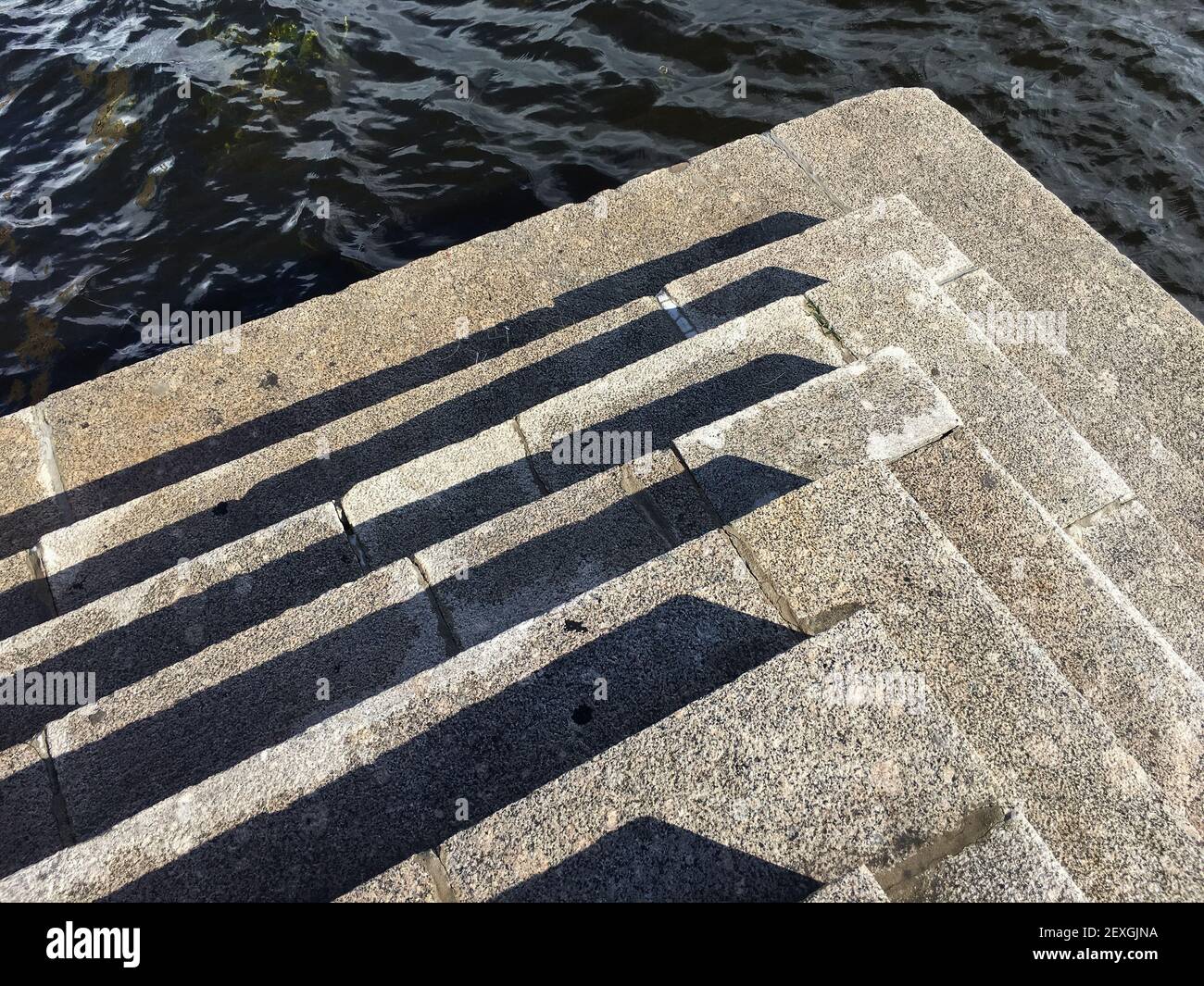 Granite stairs steps at river embankment background. City construction ...